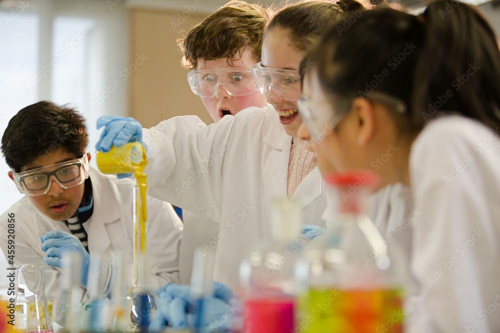 Surprised students conducting scientific experiment, watching chemical ...