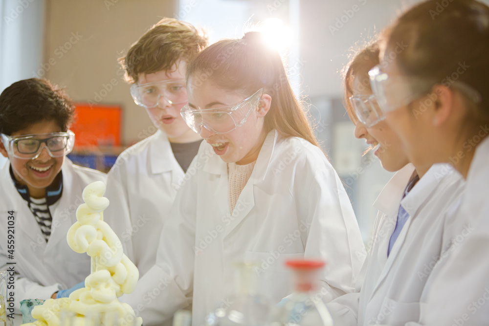 Surprised students conducting scientific experiment, watching chemical ...