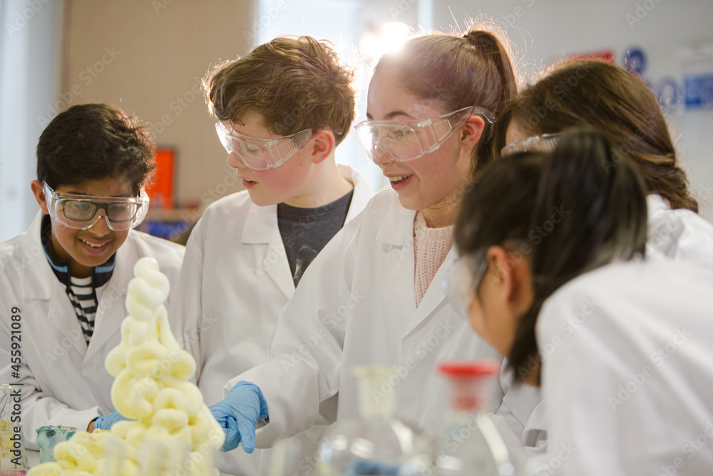 Surprised students conducting scientific experiment, watching chemical ...