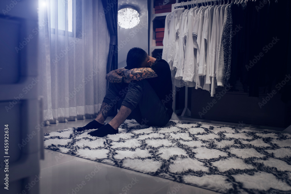 Sad young man sitting in the bedroom, People with depression concept ...