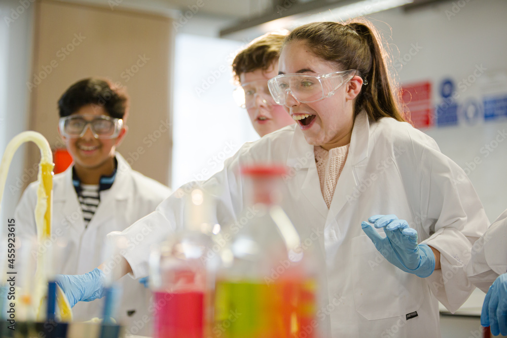 Surprised students conducting scientific experiment, watching chemical ...