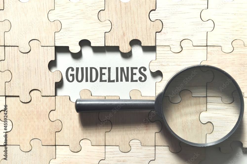 Guidelines wording with a magnifying glass and pieces of puzzle ...