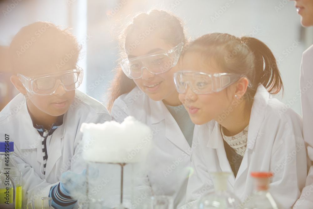 Surprised, curious students watching chemical reaction, conducting ...