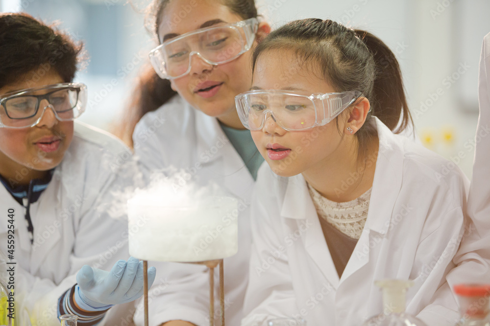 Surprised, curious students watching chemical reaction, conducting ...