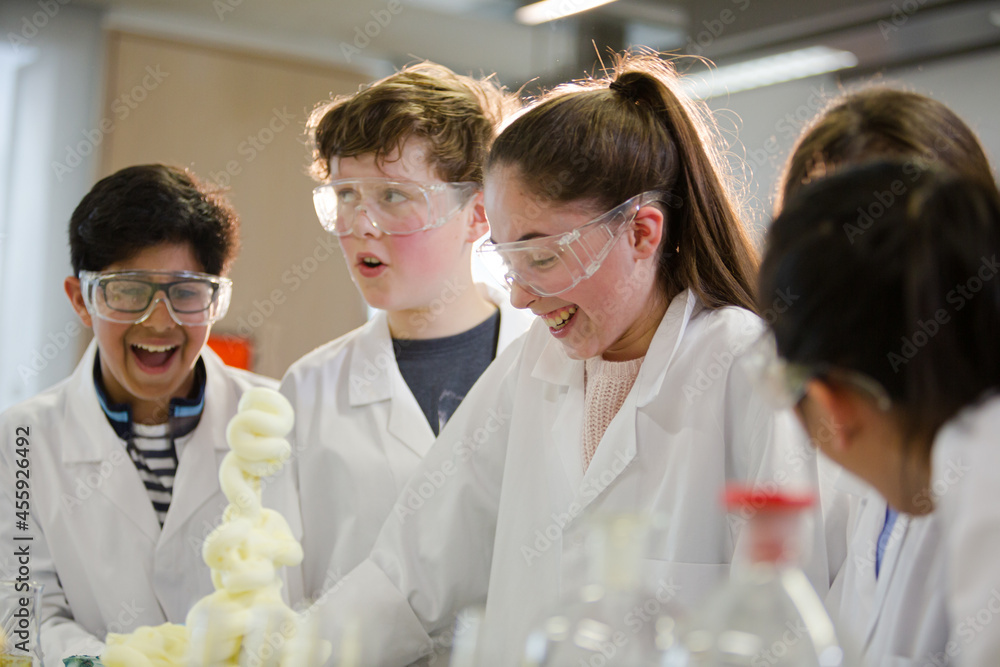 Surprised students conducting scientific experiment, watching chemical ...