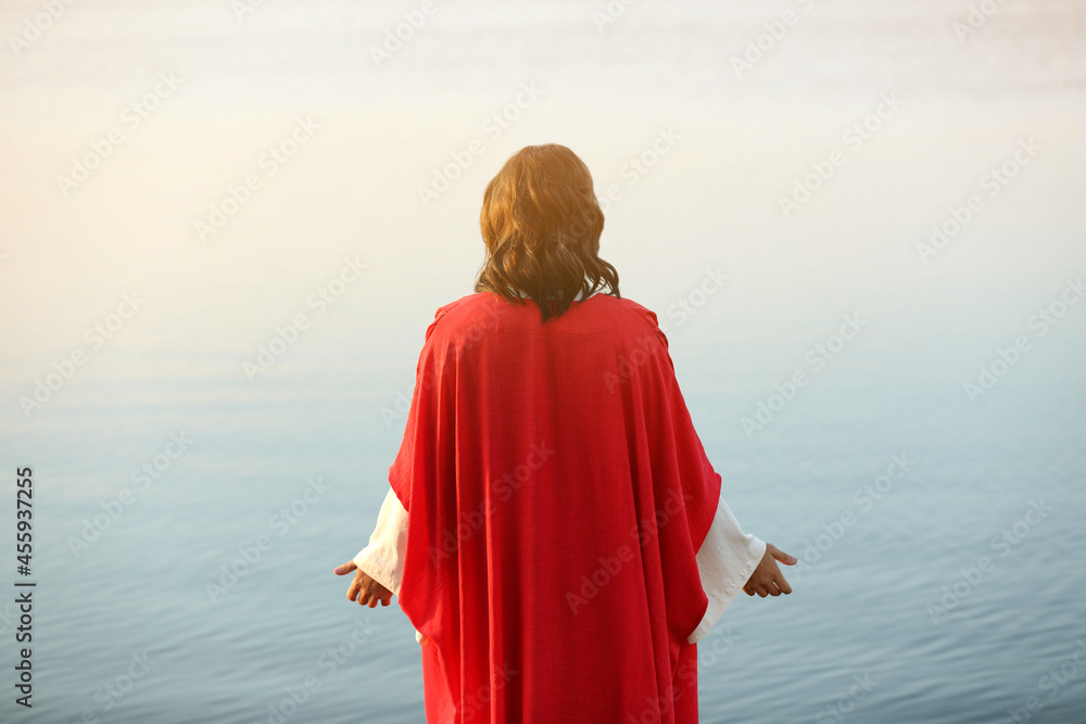Jesus Christ near water outdoors, back view Stock Photo | Adobe Stock
