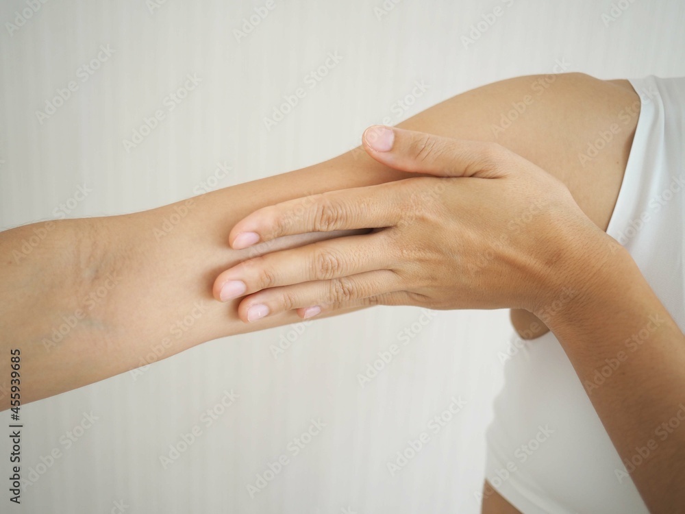 Asian woman anoint white lotion cream on her arm on white background ...