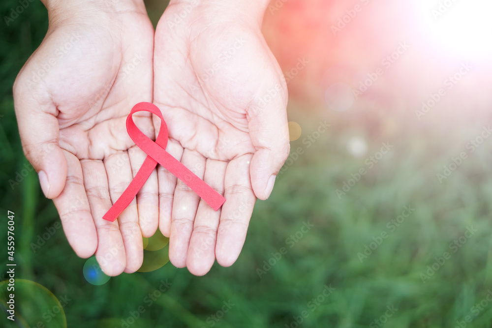 Red ribbon in hands. Concept : Aids, alcohol, tobacco, drugs and ...