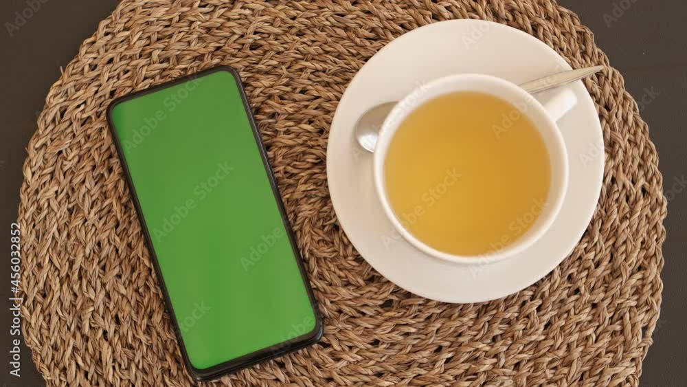 Smartphone place on table wood with green screen, Close-up the cell ...