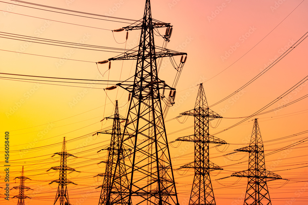 Power lines at the sunset background. High voltage pole mountain in the ...