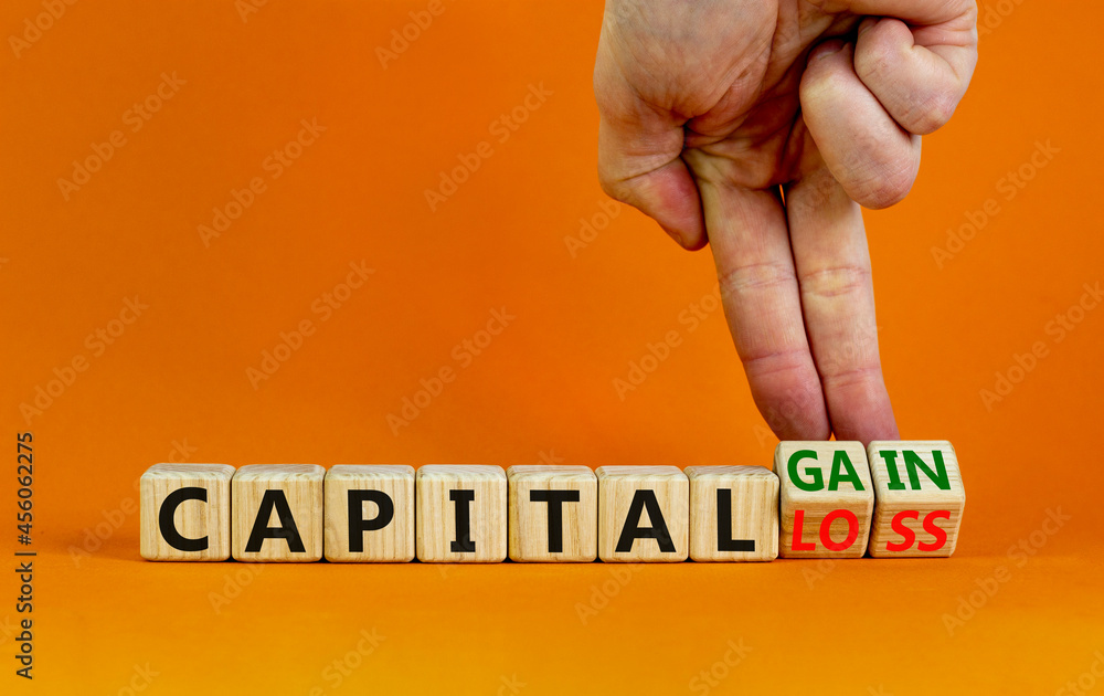 Capital loss or gain symbol. Businessman turns cubes and changes words ...