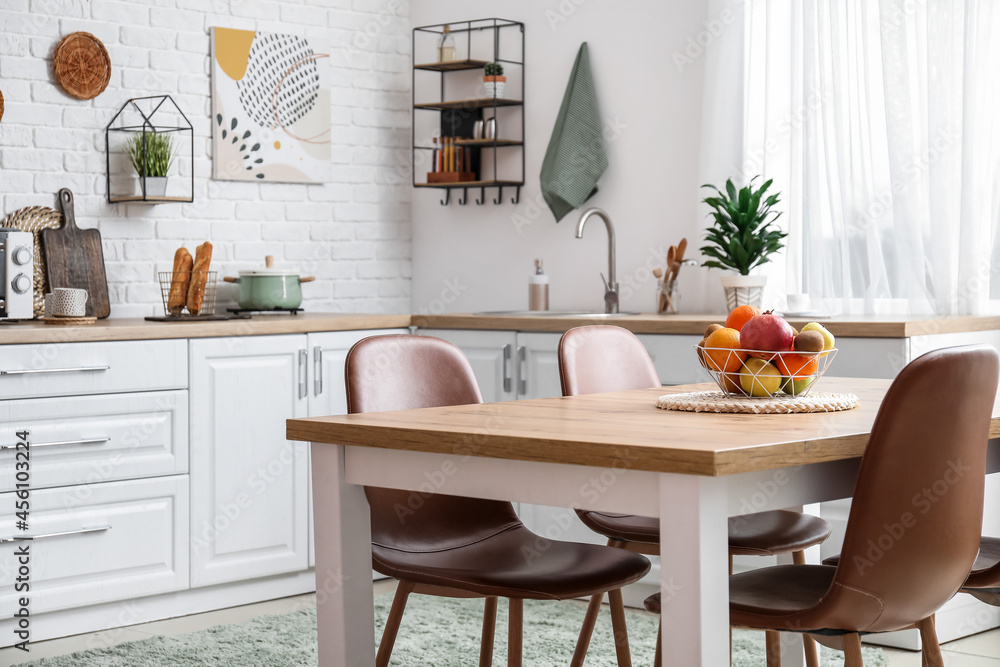 Stylish interior of modern kitchen with dining table Stock Photo ...