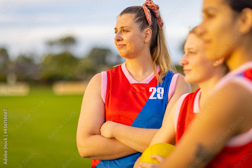 three female footballers standing proudly with arms crossed Stock Photo ...