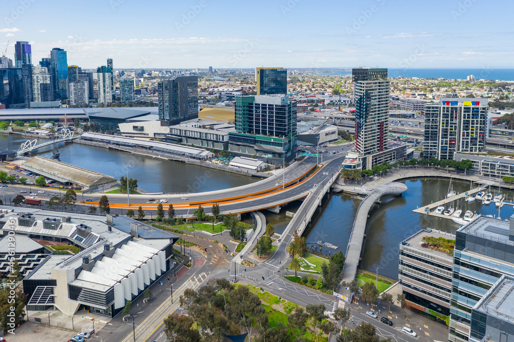 Aerial view of urbanized city with trees, bridges, roads, river and ...
