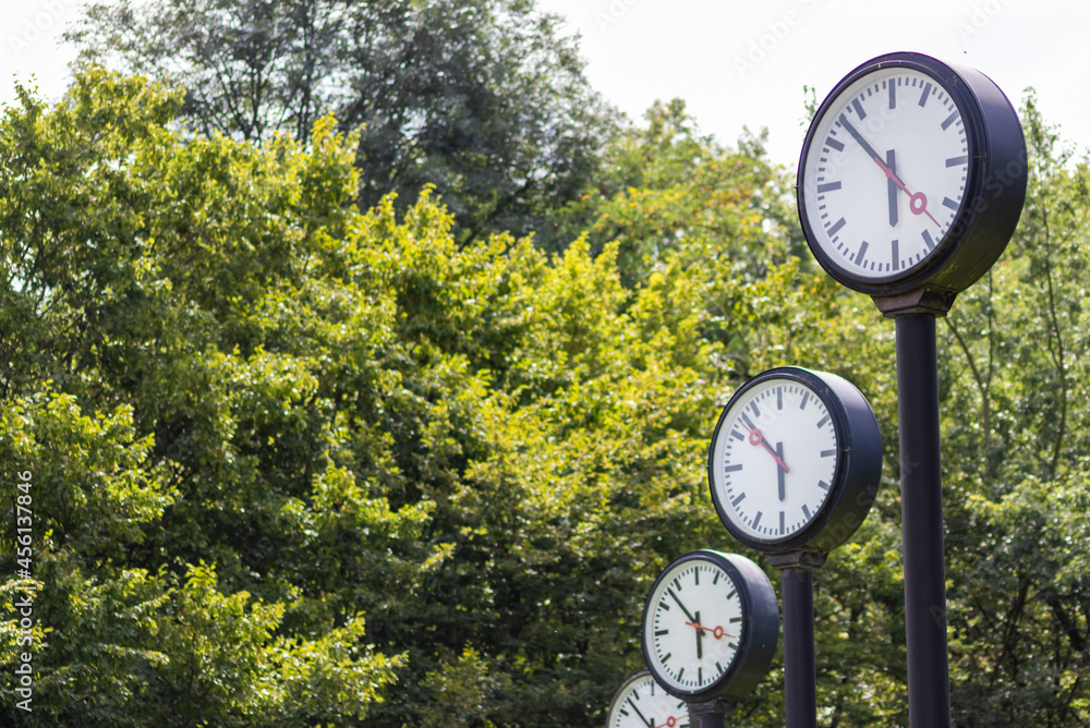 Classic black and white analog clocks with synchronized time show ...