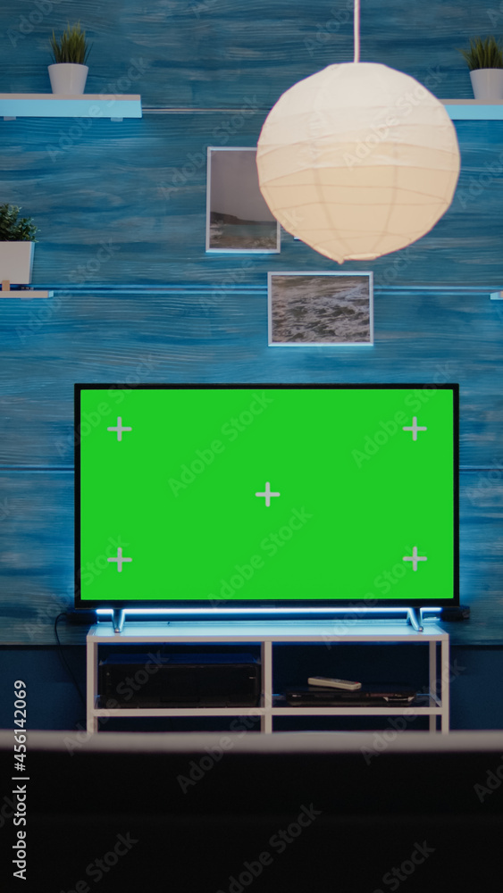 Empty modern room designed with green screen on tv at home. Nobody in ...