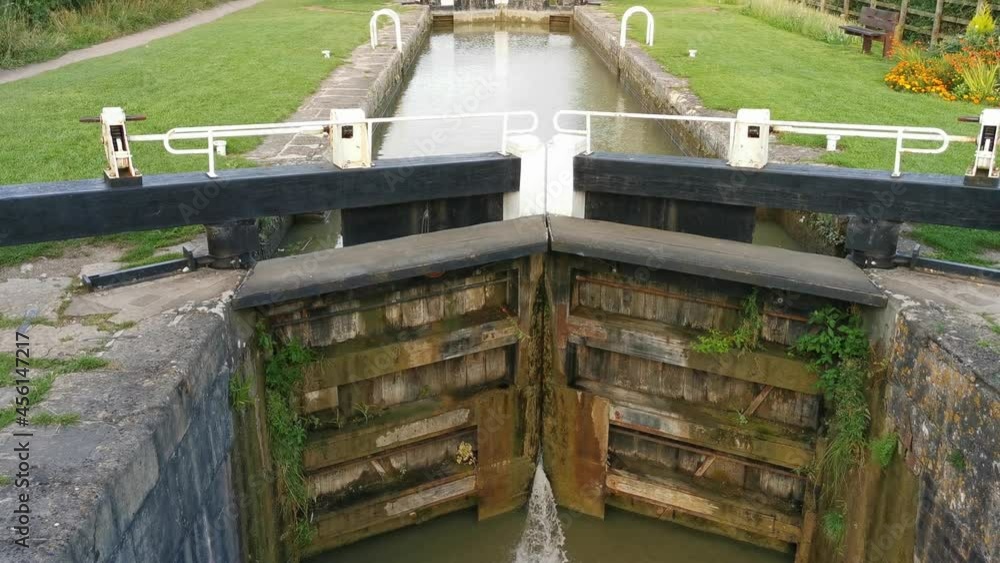 a slow rising reveal shot of a very large and old wooden locks on a ...
