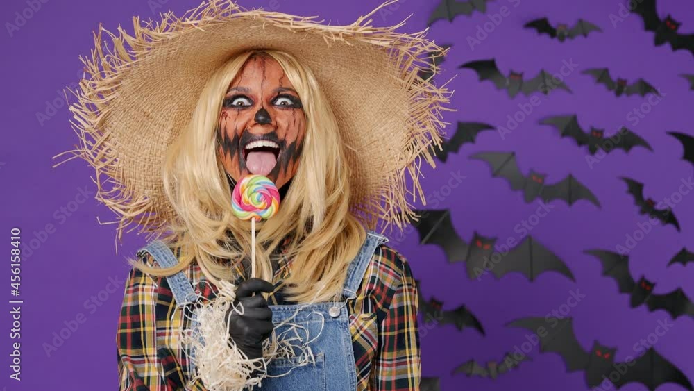 Scary fun young woman with Halloween makeup mask wears straw hat ...