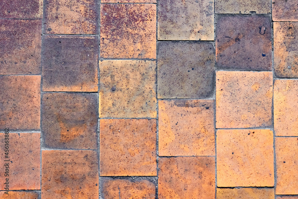 Orange brown purple old shabby worn out floor tiles with damages cracks ...