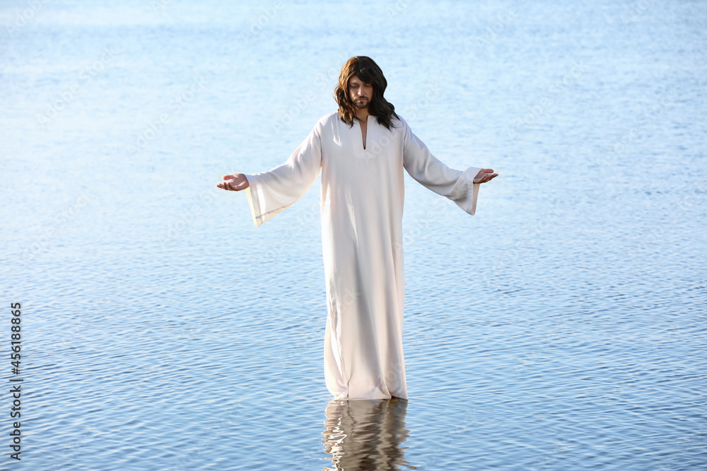Jesus Christ in water lit by morning sun Stock Photo | Adobe Stock