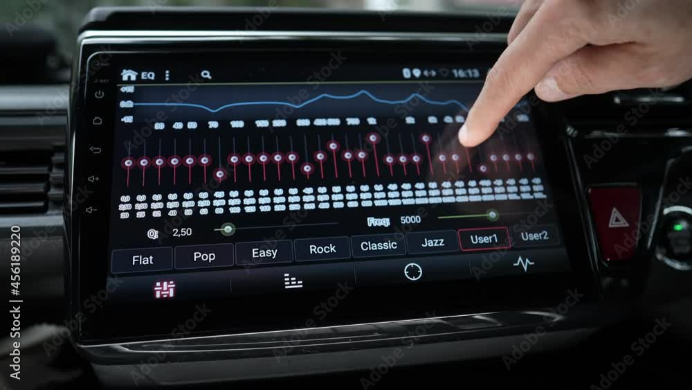 Man finger changing car audio equalizer settings using smart multimedia ...