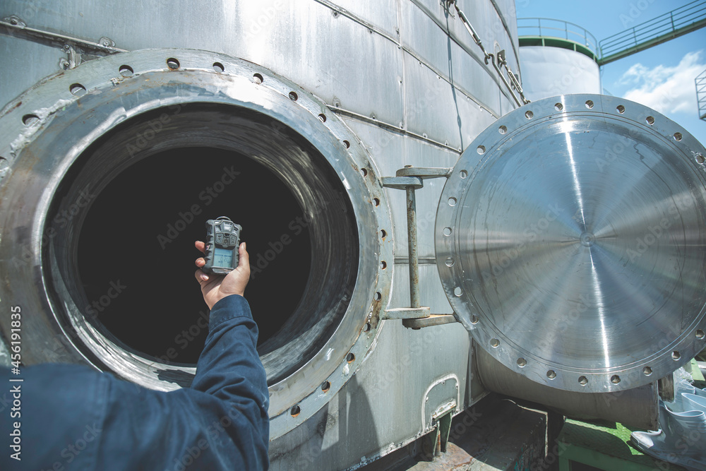 Worker hand holding gas detector inspection safety gas testing at front ...