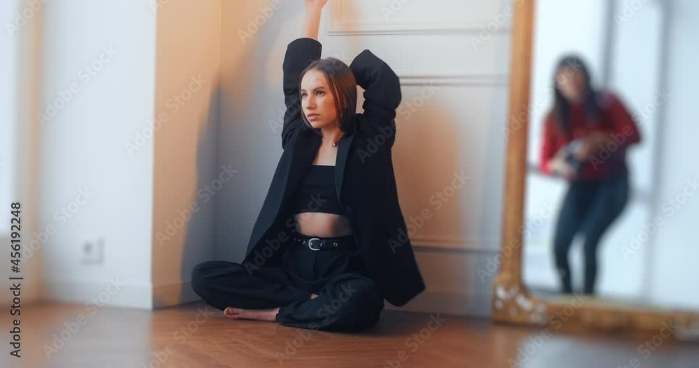 Young model and photographer. Female photographer shows the pose to ...