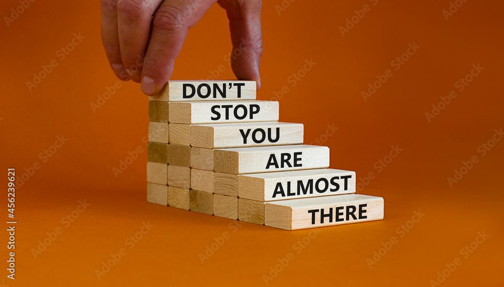 You are almost there symbol. Wooden blocks with words 'dont stop you ...