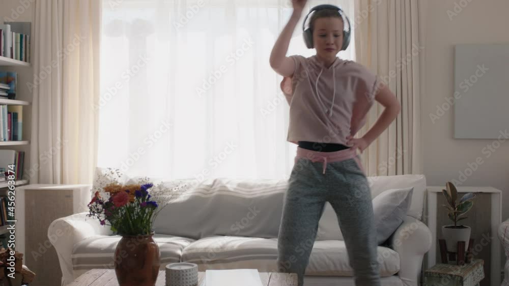 happy teenage girl dancing at home having fun listening to music ...