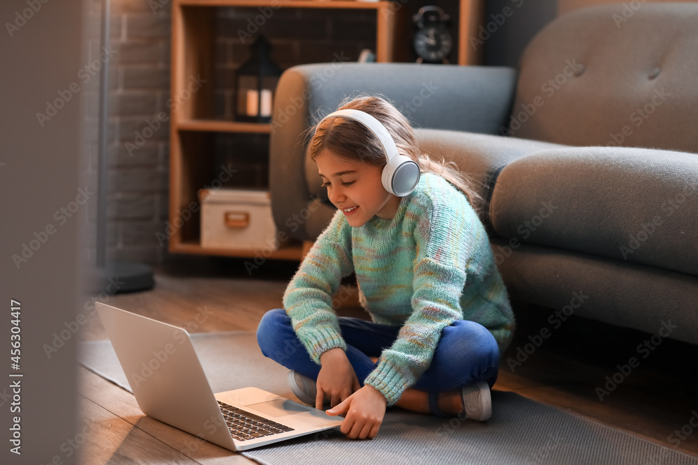 Cute girl watching cartoons at home Stock Photo | Adobe Stock
