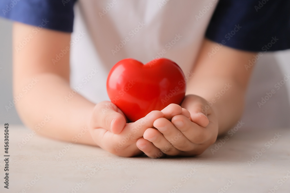 Child holding heart on light background, closeup Stock Photo | Adobe Stock