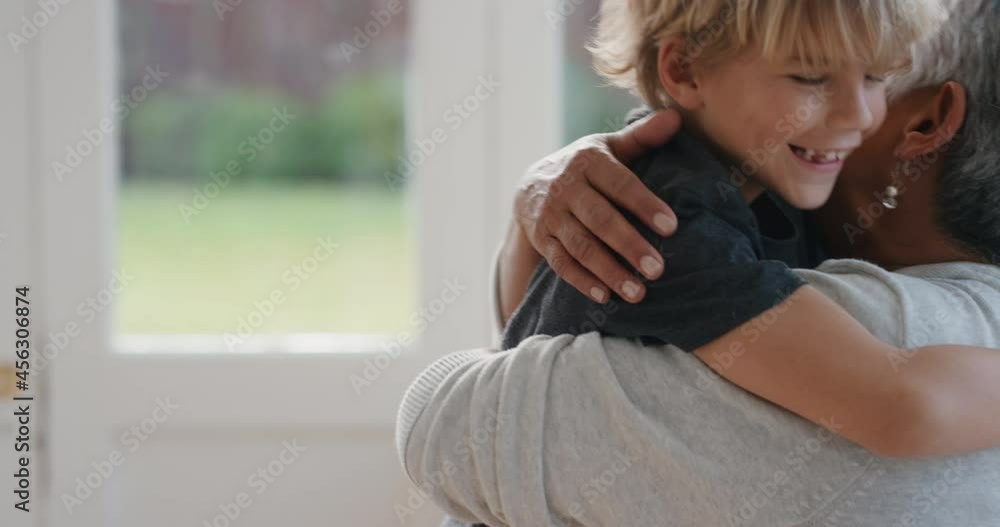 adorable little boy hugging grandmother smiling embracing her grandson ...