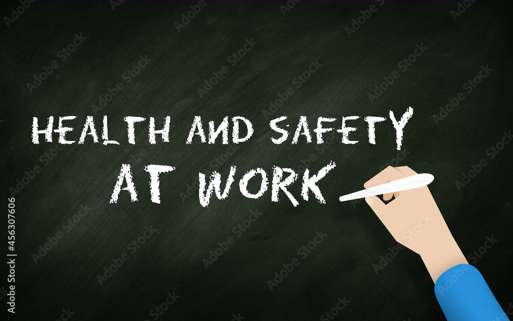 Health and Safety at Work Written on chalk background. Human hand ...