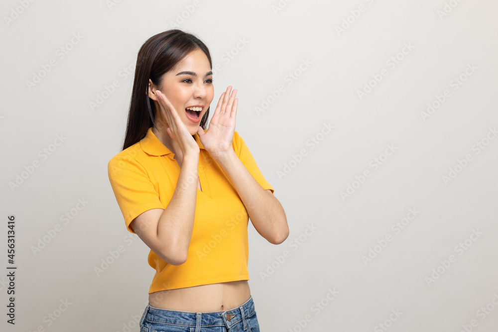 Excited asian woman shout out loud wow with hands on isolated ...