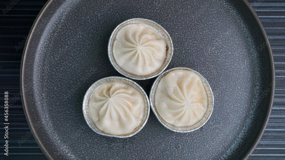 handmade steamed Shanghai Xiao long bao pork meat dumpling soup on dark ...