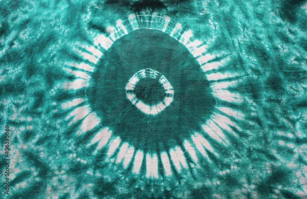 Tie dye green background with half circle layers of dye pattern fading ...