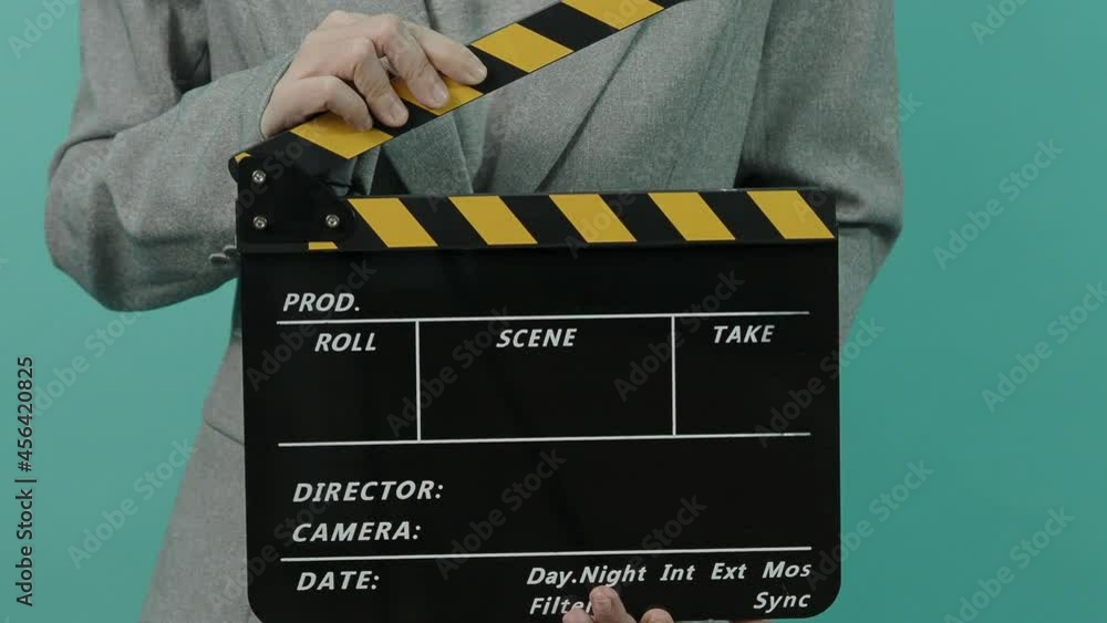 Movie slate or clapperboard hitting. Business woman holding empty film ...