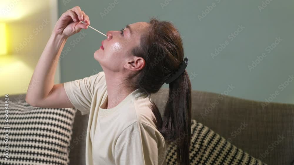 4K Asian woman using rapid antigen test kit for self test COVID-19 ...