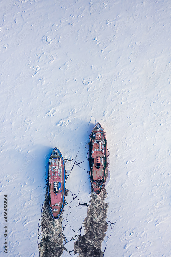 Two icebreakers breaking ice on river in winter. Stock Photo | Adobe Stock
