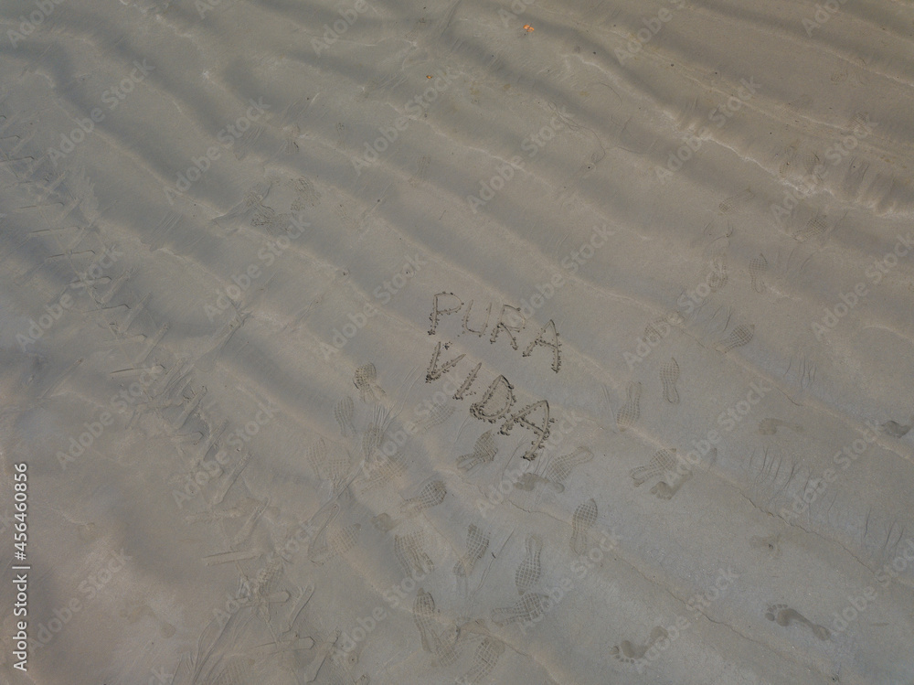 Pura Vida the Costa Rican motto written in sand and captured from a ...