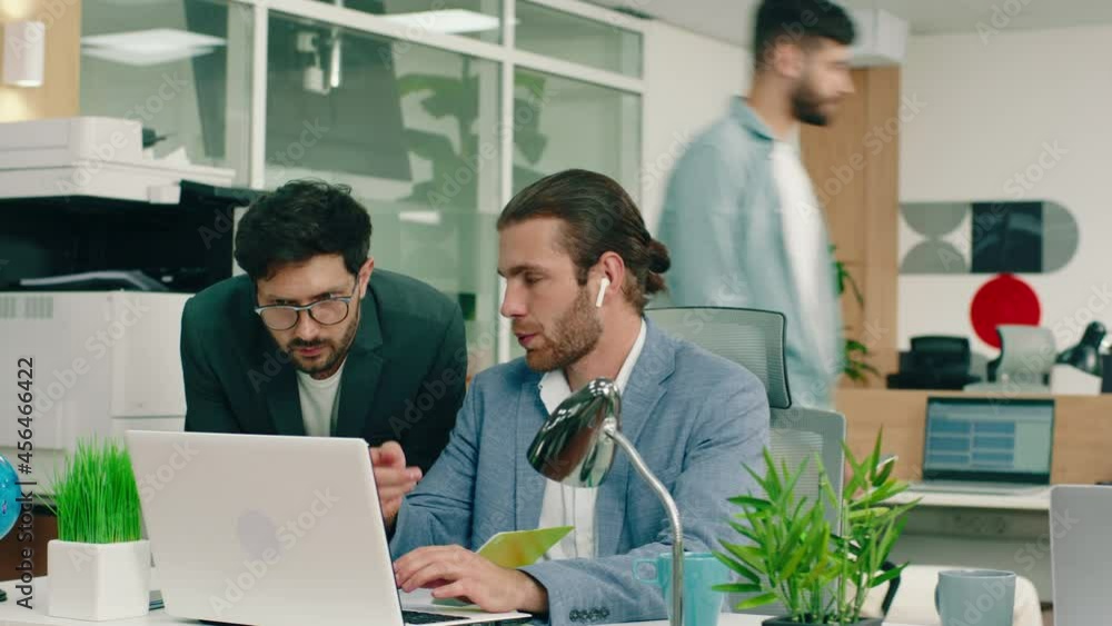 A hard working man with brown hair that s in a man bun, is showing his ...