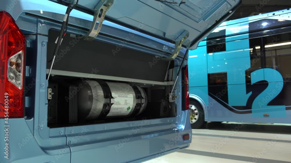A hydrogen fuel cell buses. One bus with an open hood and a hydrogen ...