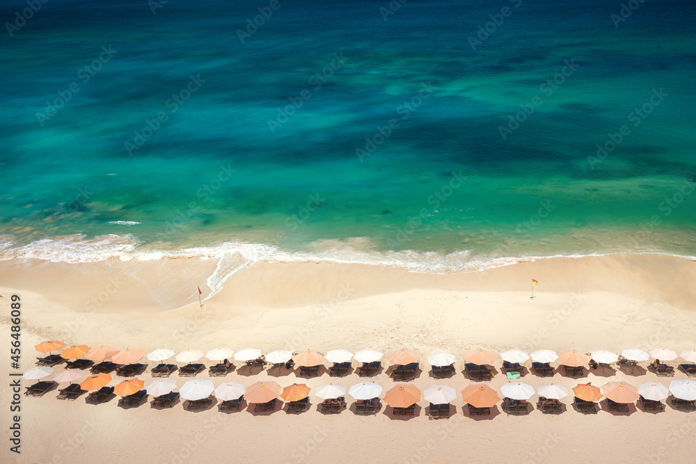 An overhead view of beach chairs set up on a Bali beach in the morning ...