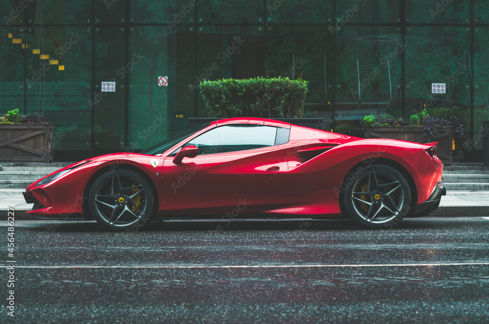 Red Ferrari F8 Spider parked on the street in Moscow. Supercar in front ...