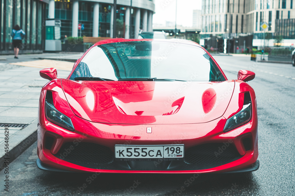Red Ferrari F8 Spider parked on the street in Moscow. Supercar in front ...