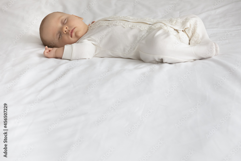 Peaceful calm sweet baby wearing body sleeping on soft mattress. Cute ...