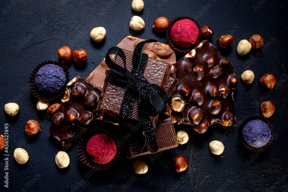 Chocolate bar, crushed pieces of dark chocolate and nuts. Praline ...