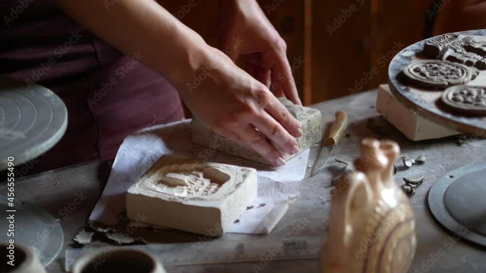 Traditional pottery. Injection of clay into gypsum molds. The hands ...
