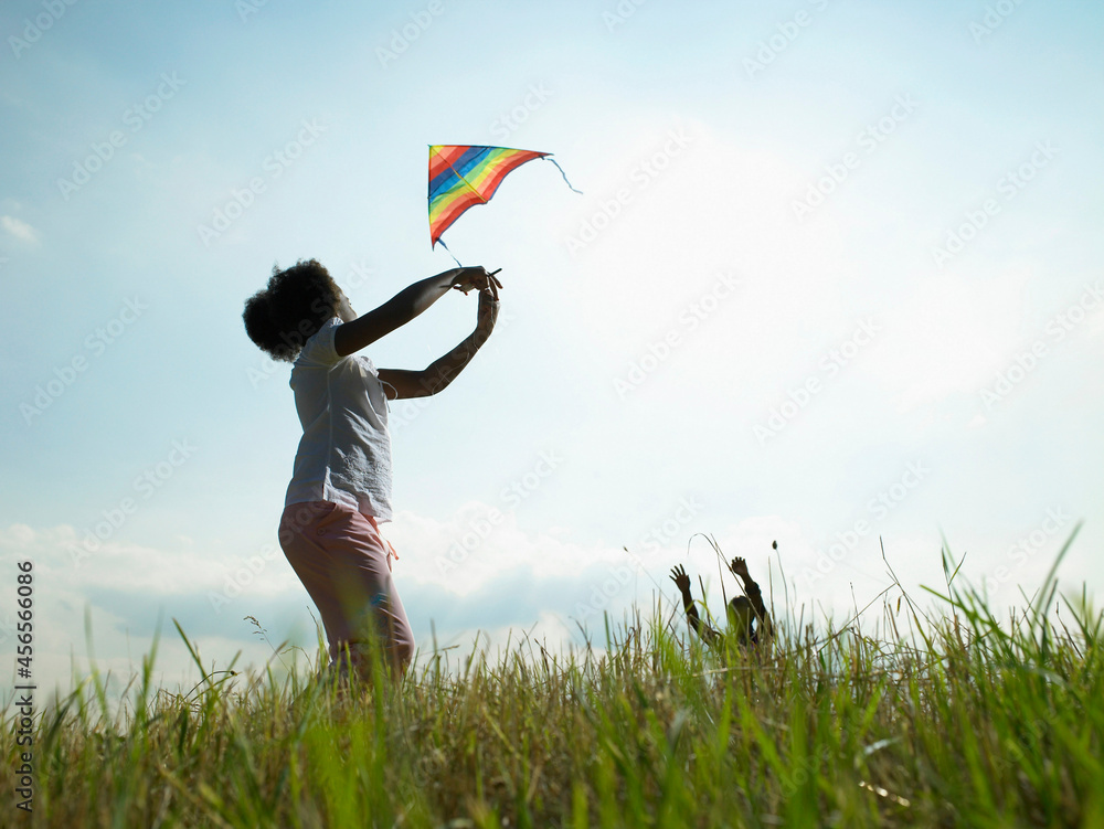 Children playing with kite in field Stock Photo | Adobe Stock