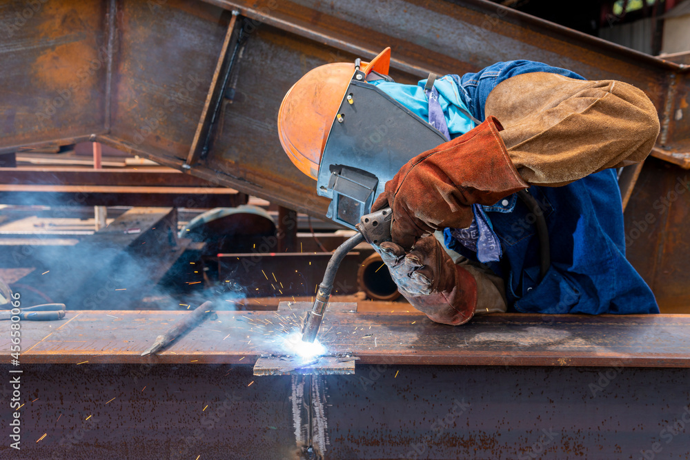 Welder is welding add joint h-beam for steel structure work with ...